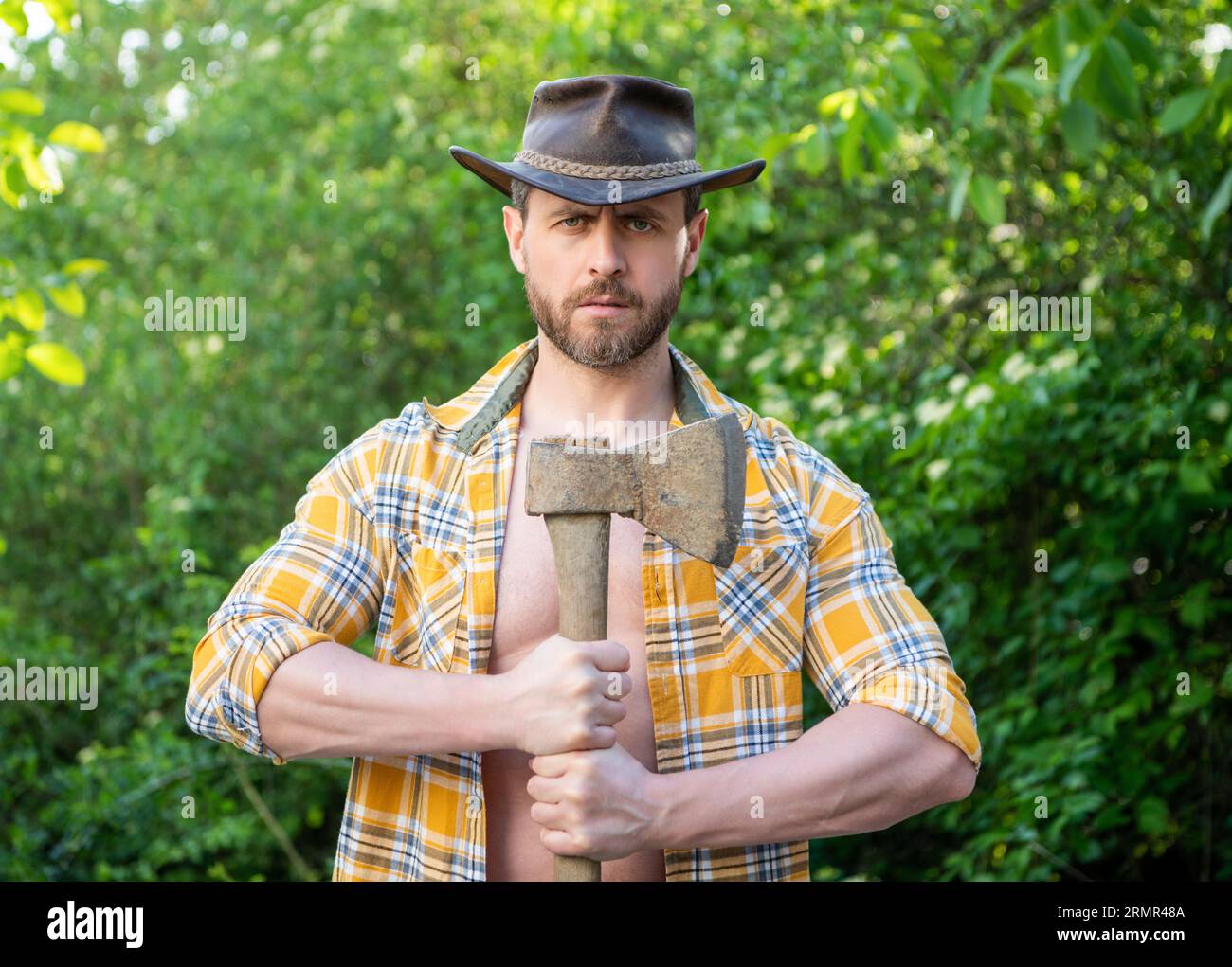caucasian lumberjack with axe. lumberjack with axe wearing checkered ...