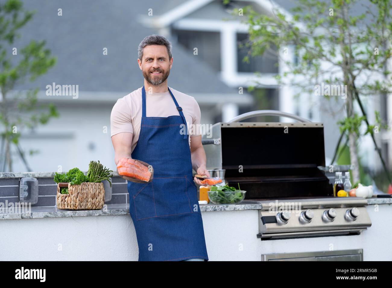 chef with grilled salmon, copy space. chef man cooking grilled salmon ...