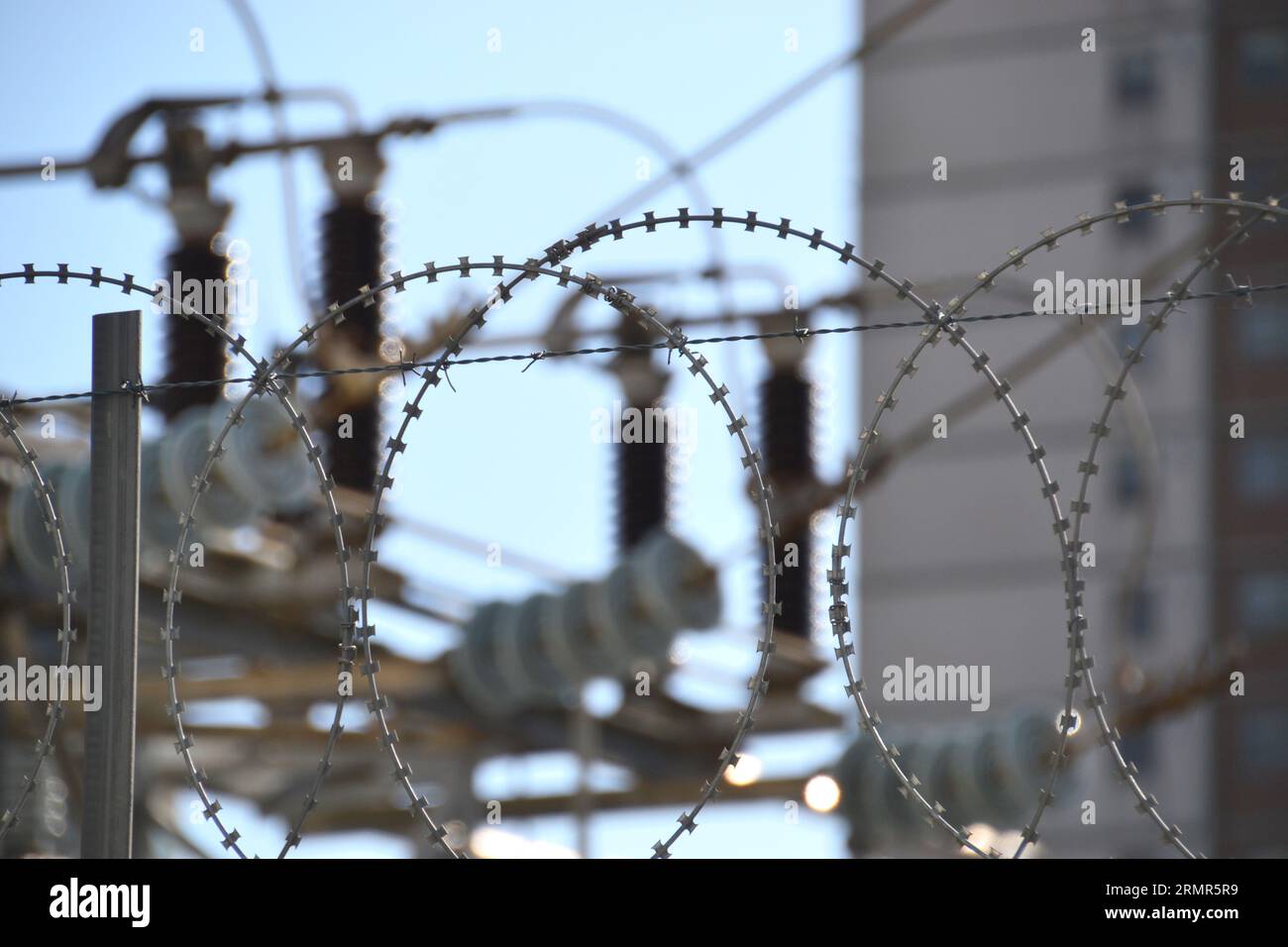 Barbed wire fence protecting electrical substation with plastic and ...