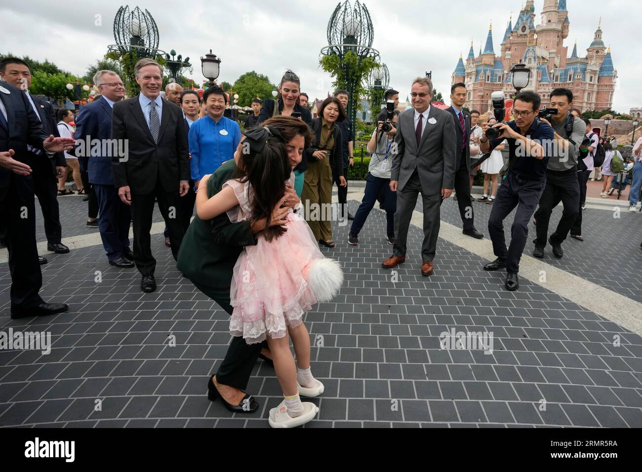 U.S. Commerce Secretary Gina Raimondo hugs a young girl wearing a ...