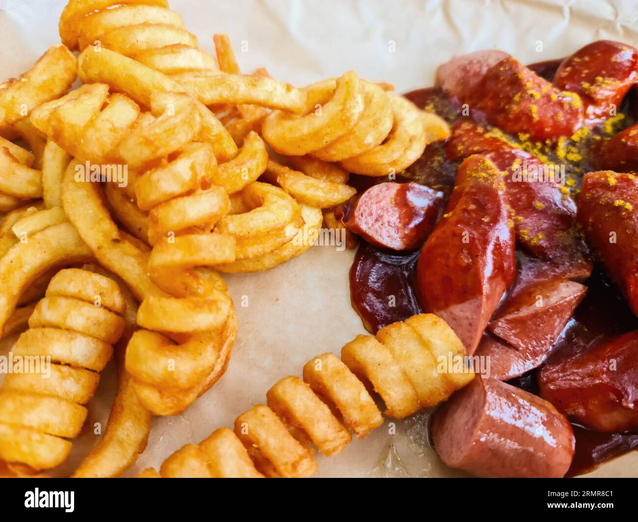 Traditional German Currywurst, Served With Chips On A White Plate ...