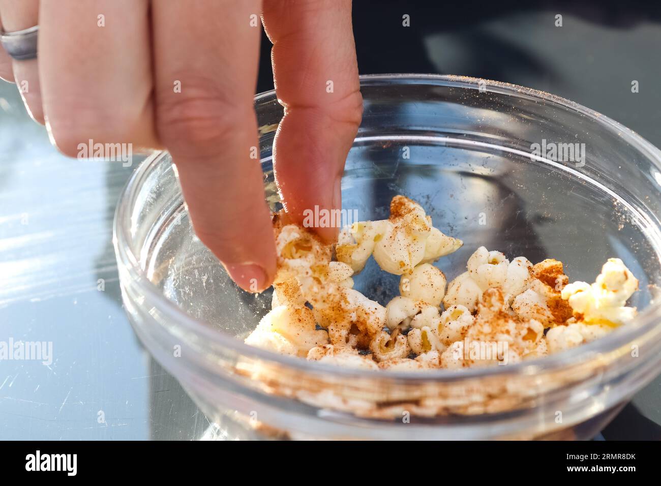 Female Hand Taking Popcorn Out Of A Glas Bowl Stock Photo - Alamy