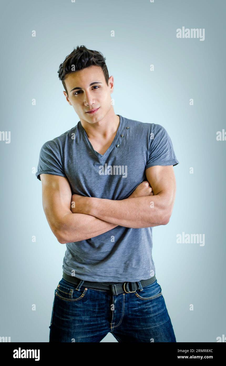 A man with his arms crossed posing for a picture. Photo of a confident ...