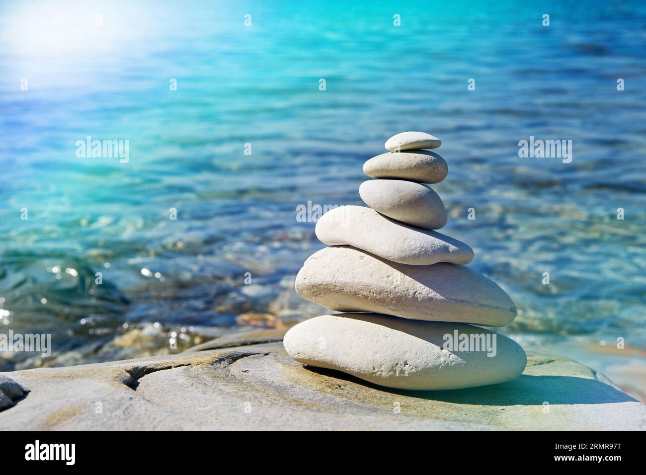 Pyramid of stones zen balance in sea on sunny day Stock Photo - Alamy