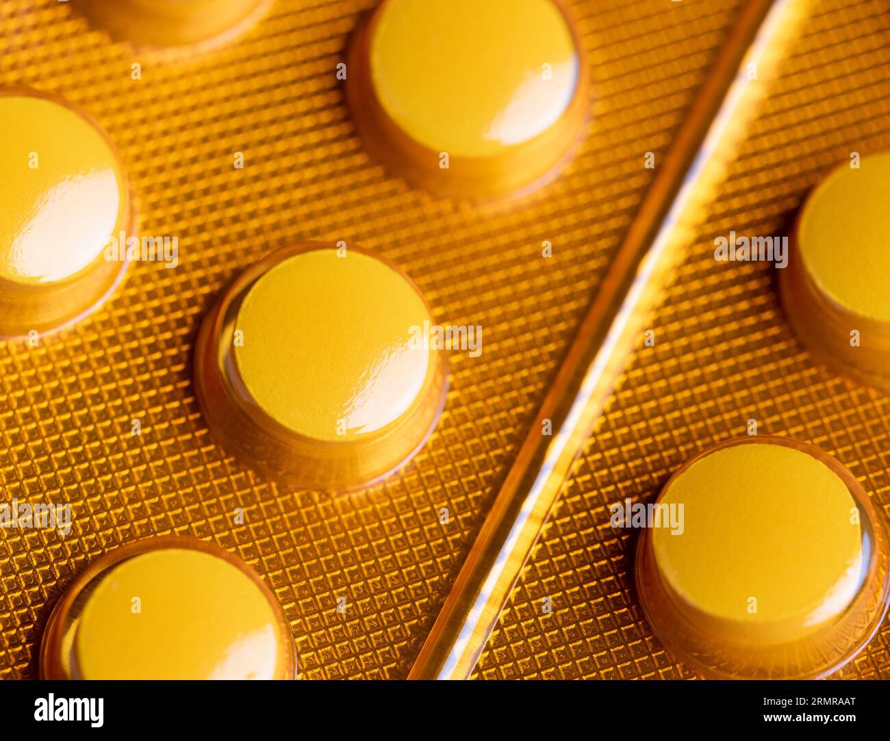 Tablets packed in a yellow blister, a package of tablets closed in a ...
