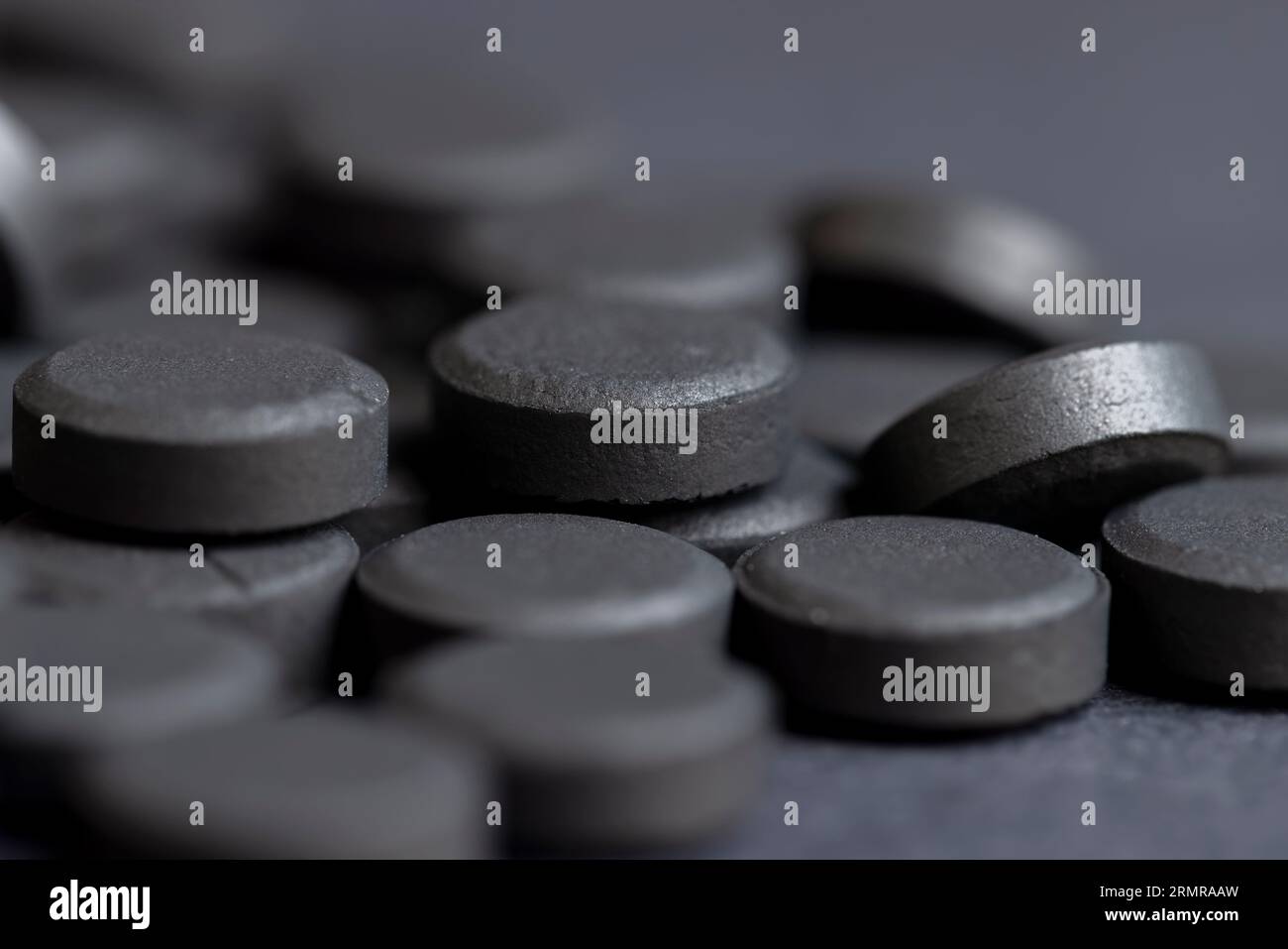 Open and unpacked tablets of black color close-up, several of the same ...