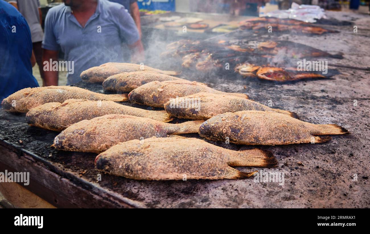 Fish frying on street roaster Stock Photo - Alamy