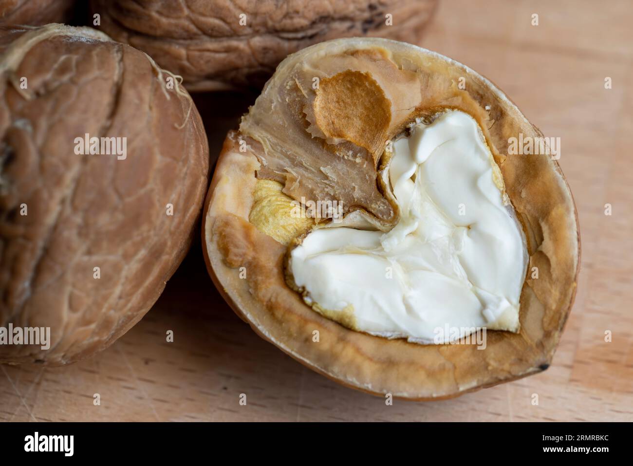 Open and broken walnut shells lying on the table , soft fresh and not ...