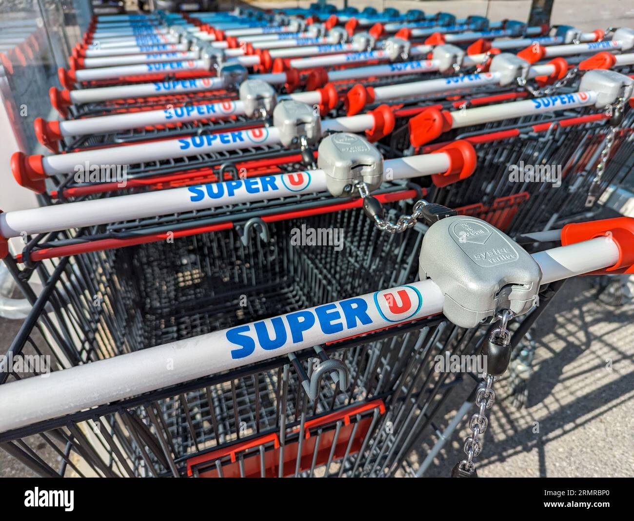 Close-up of many shopping carts marked with the logo of a Super U ...