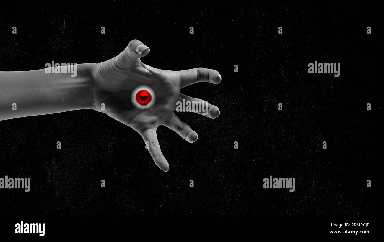 Black and white image of female hand with terrifying red eyes on palm ...