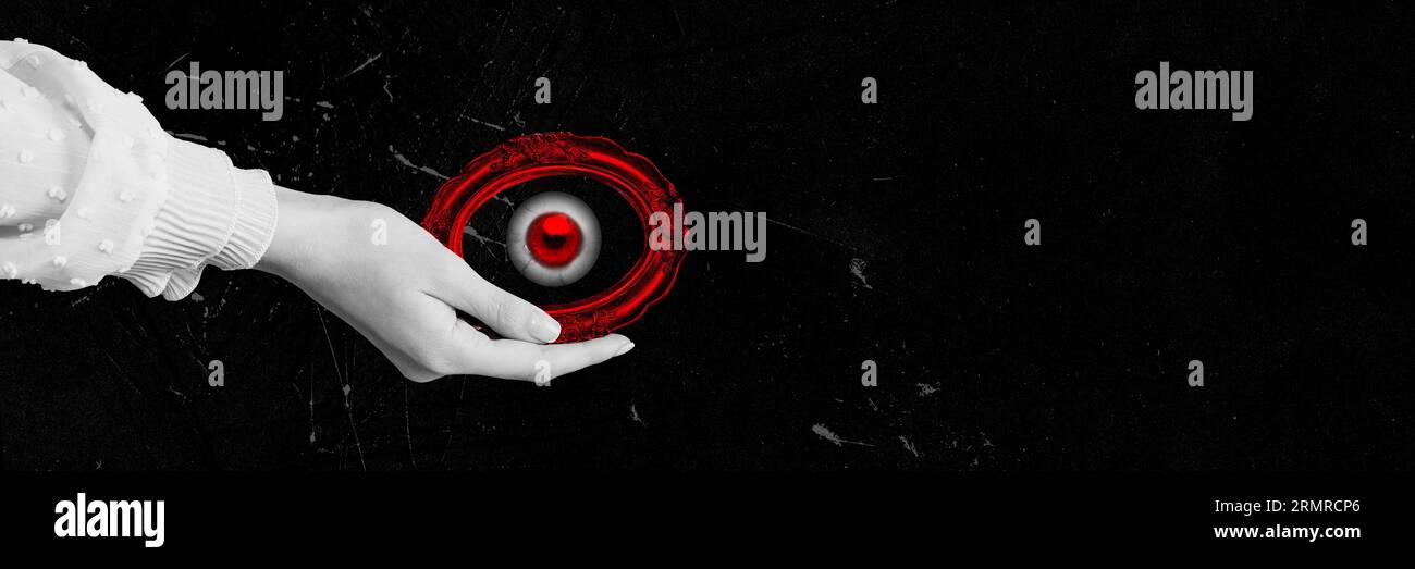 Female hand holding eye in mirror over black background. Witch vision ...