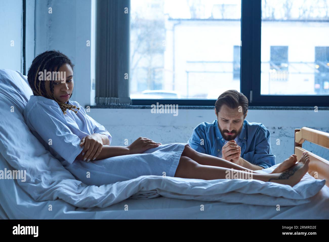 miscarriage concept, man grieving near depressed african american woman ...