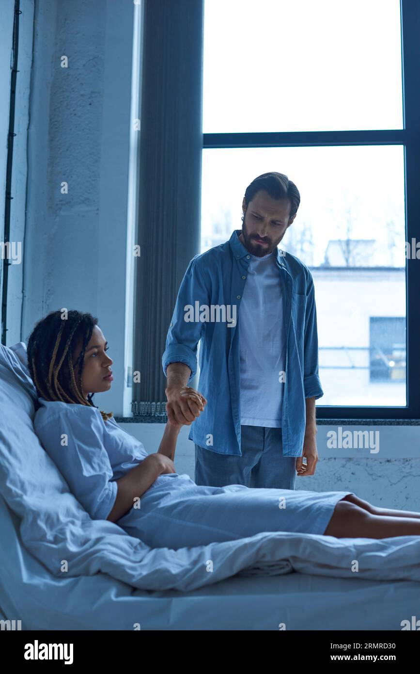 Miscarriage Concept Sad Man Holding Hand Of African American Wife