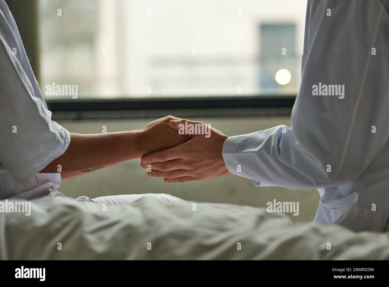 doctor comforting african american woman, holding hands of patient ...