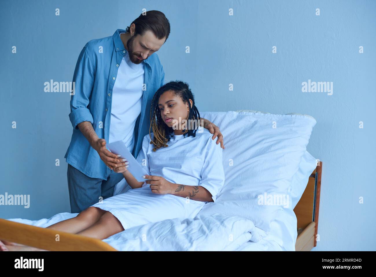 Man Standing Near Sad African American Wife Looking At Ultrasound
