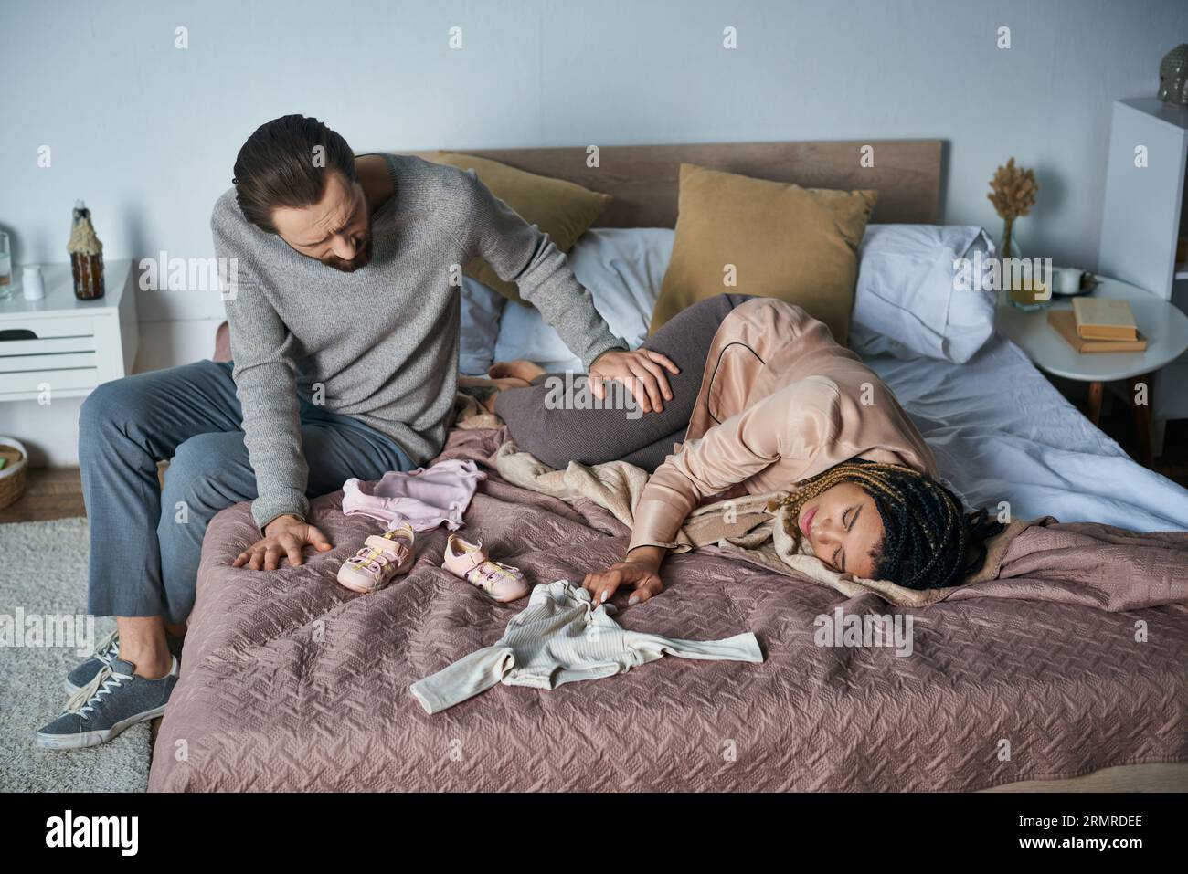 grief, miscarriage concept, man calming african american wife crying ...