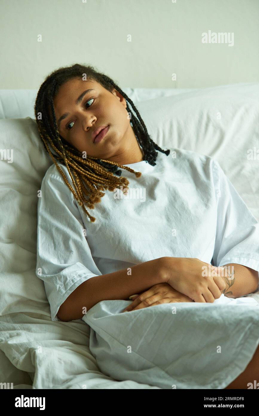 grief, depressed african american woman lying in private ward, hospital ...