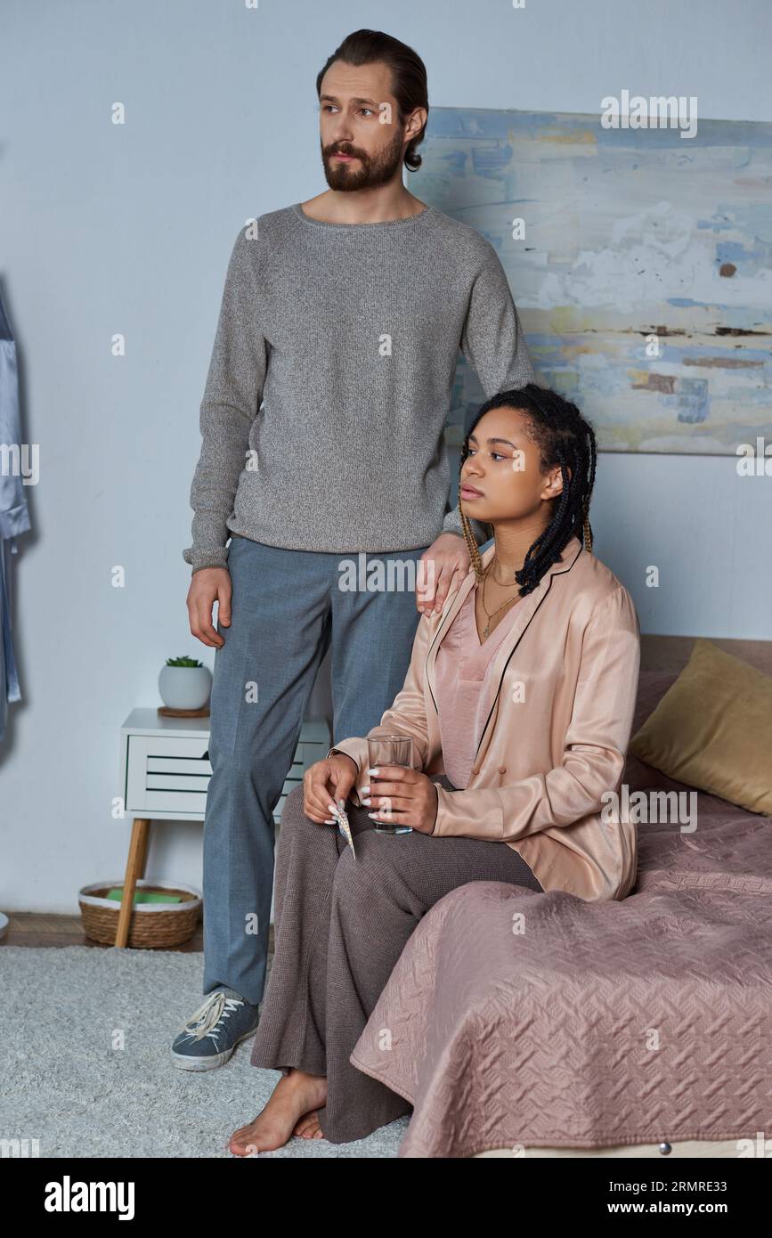 pregnancy and abortion, man calming african american woman, glass of ...
