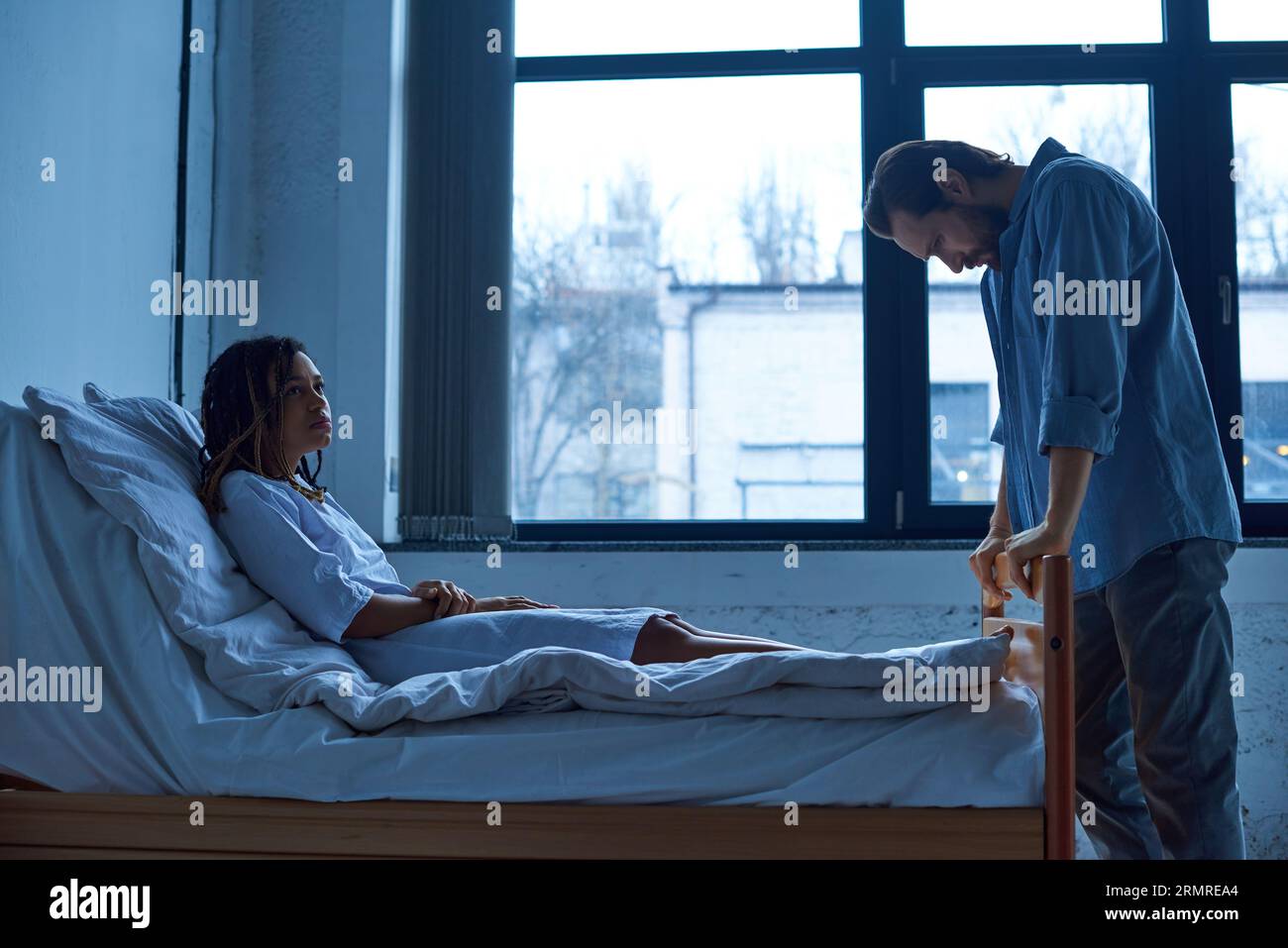 man grieving near depressed african american wife, standing near ...