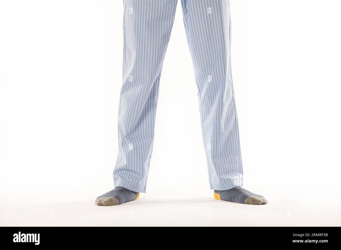 Man wearing a pajama. Legs detail over a white background Stock Photo ...