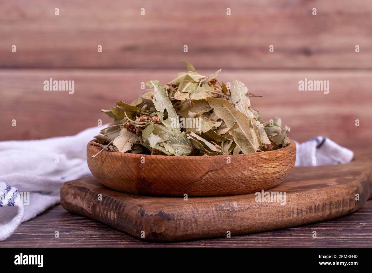 Dried linden flowers. Fresh flowers and leaves of linden in wood bowl ...