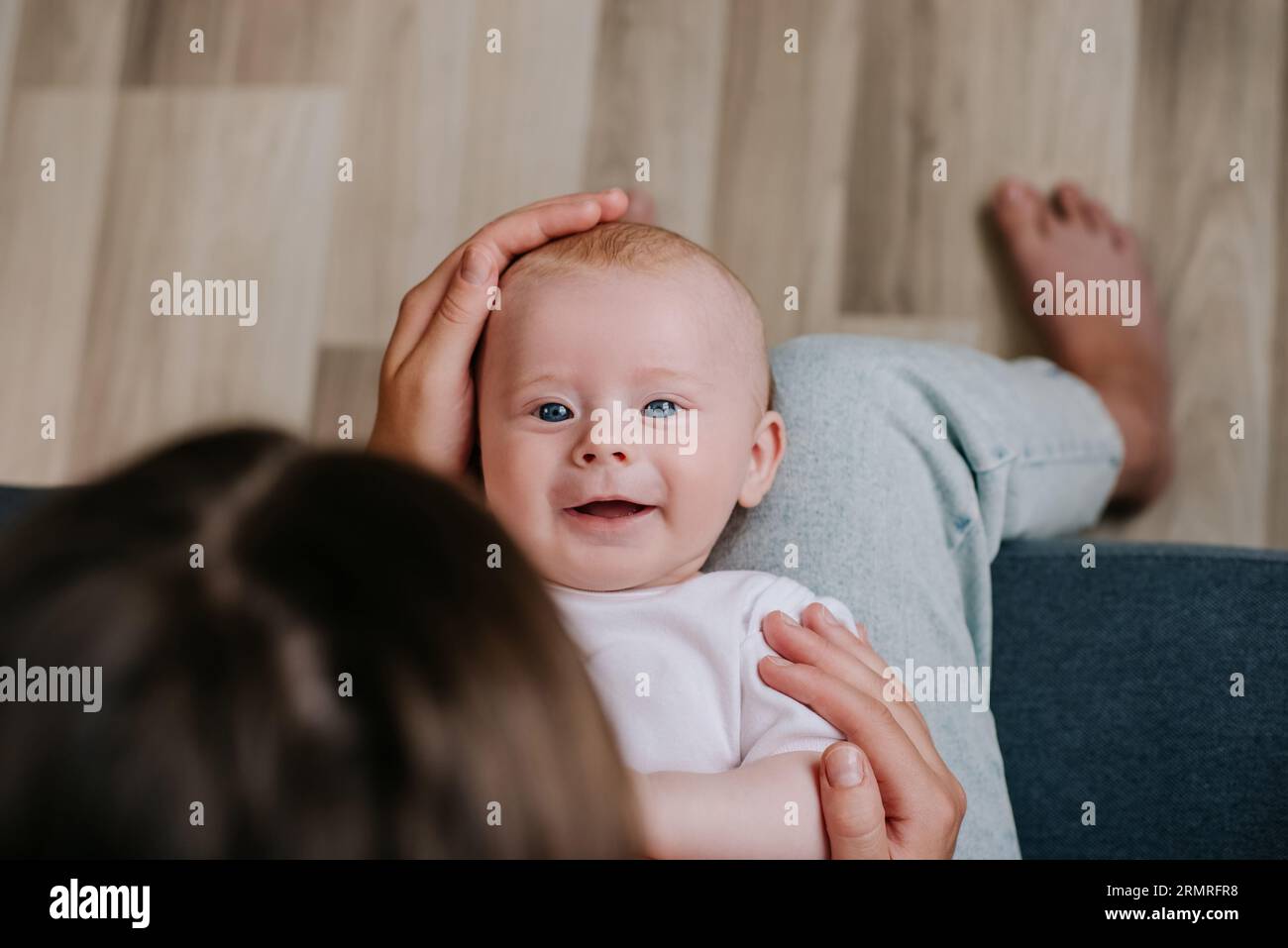 Close up top view of caring young mother embracing happy cute baby son ...