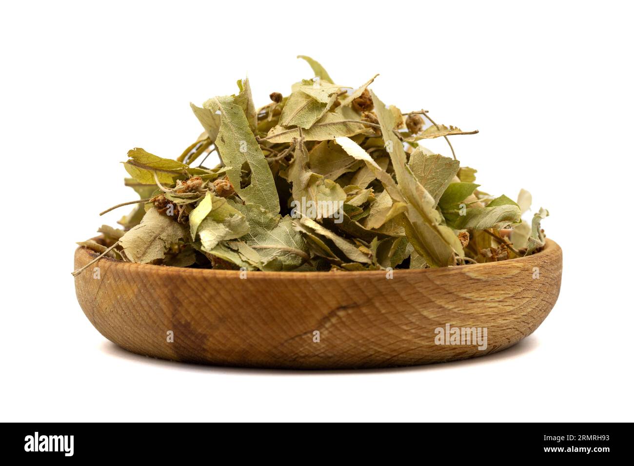 Dried linden flowers. Fresh flowers and leaves of linden in wood bowl ...