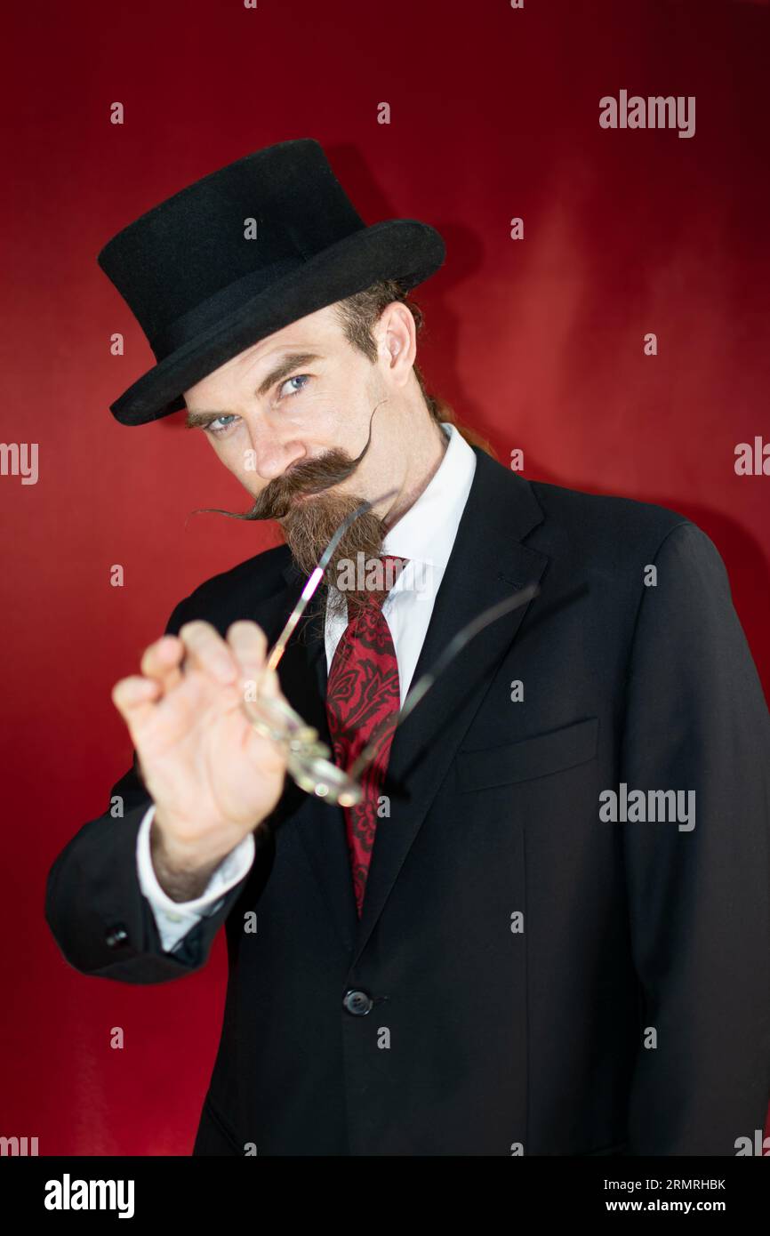 Vintage Caucasian Magician with top hat, glasses and mustache posing ...