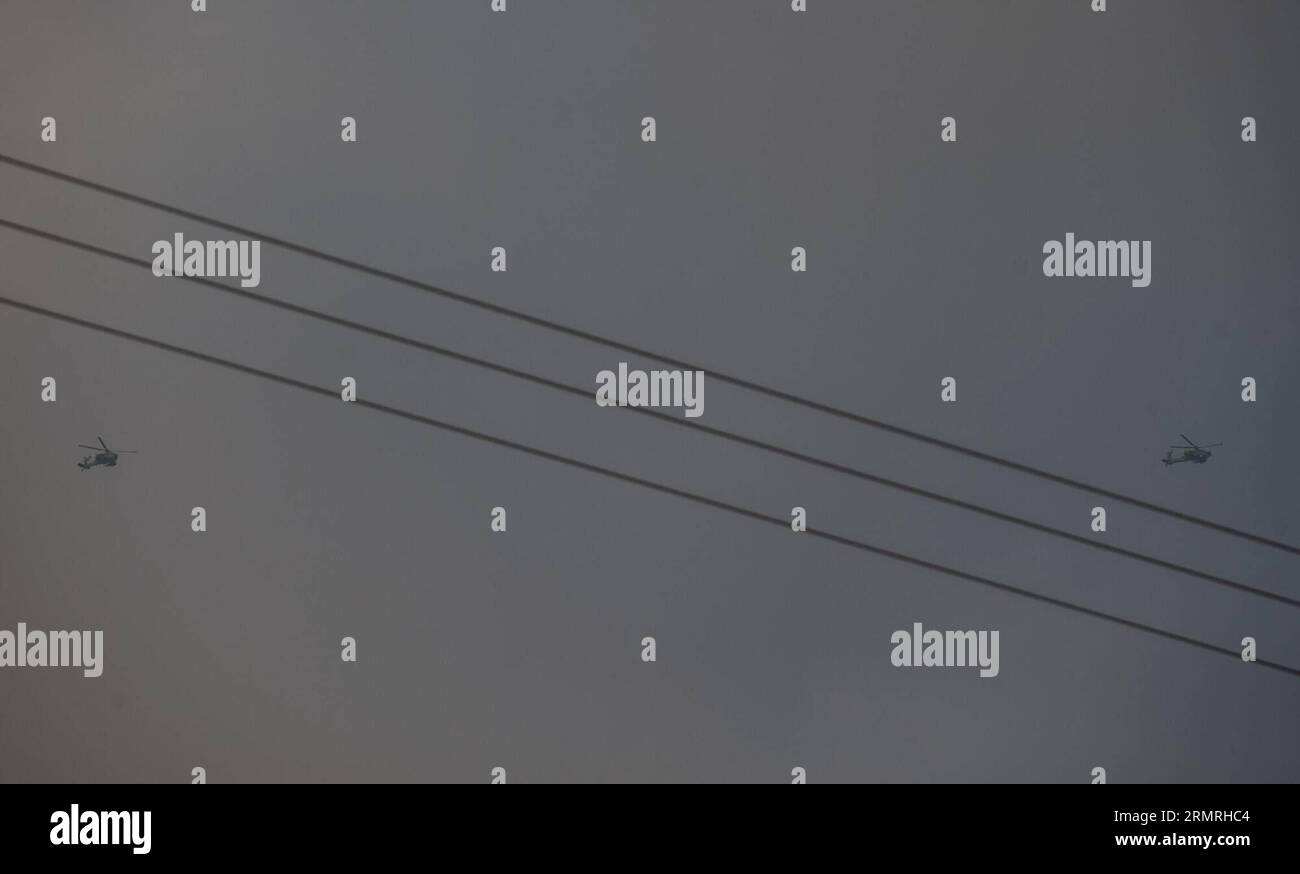 Israeli Apache helicopters fly in the air over southern Israel near the ...