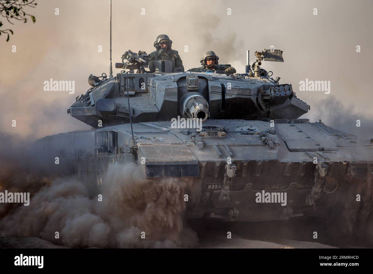 An Israeli Merkava tank runs in the field in southern Israel near the ...