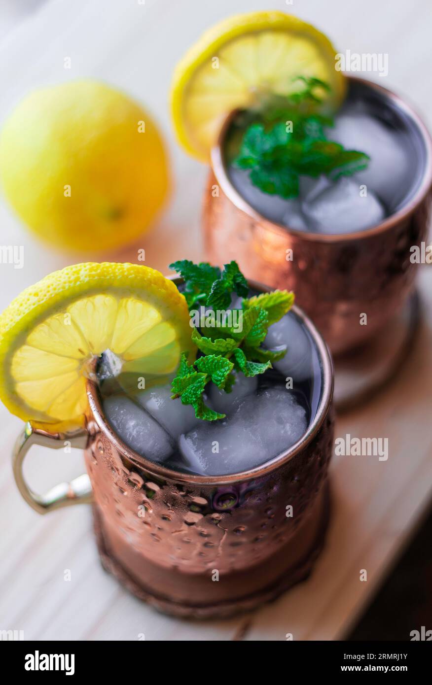 Cold drinks in copper mugs with garnish Stock Photo - Alamy