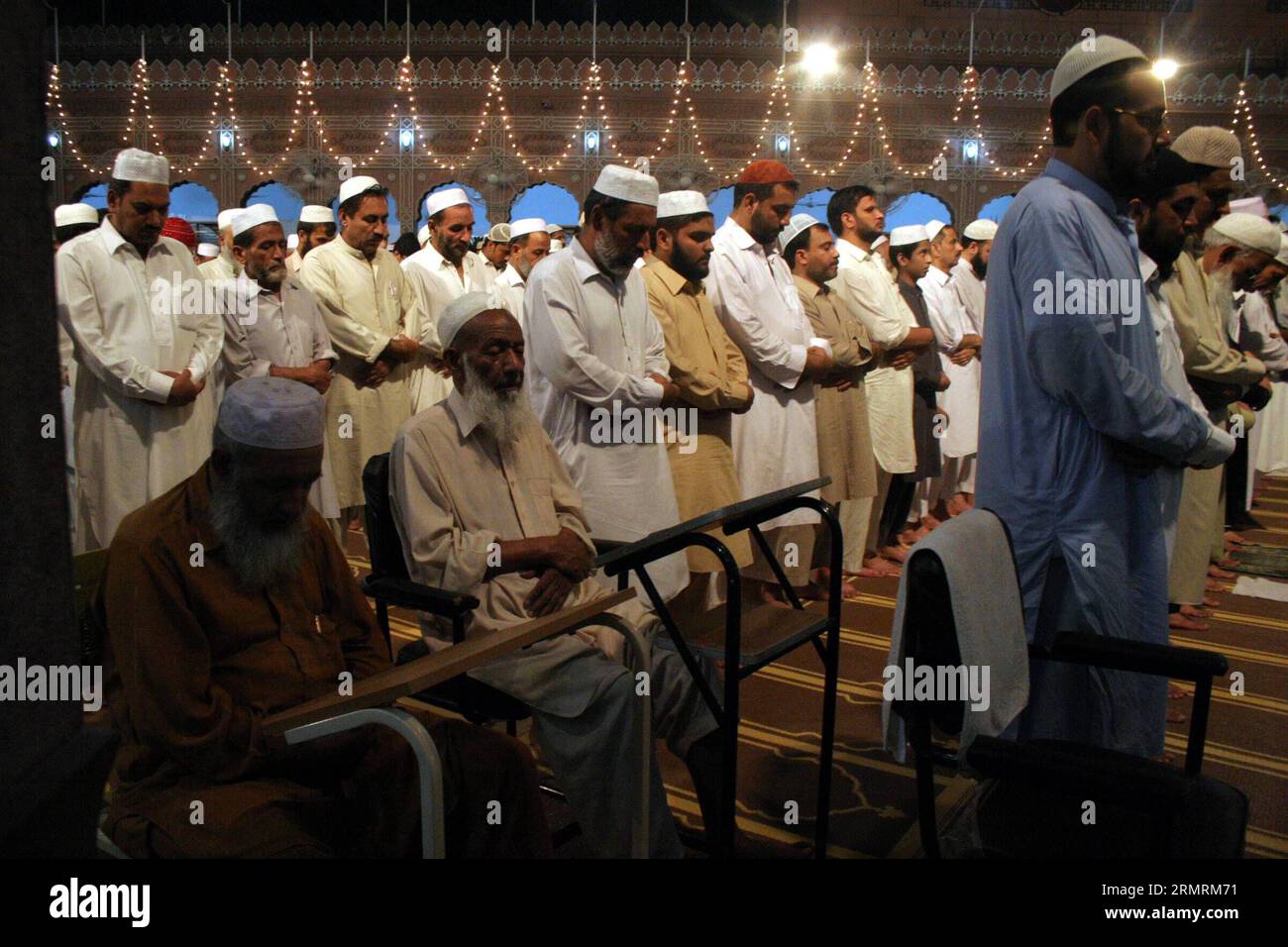 Pakistani Muslims offer prayers at a mosque during Lailat al-Qadr, also ...