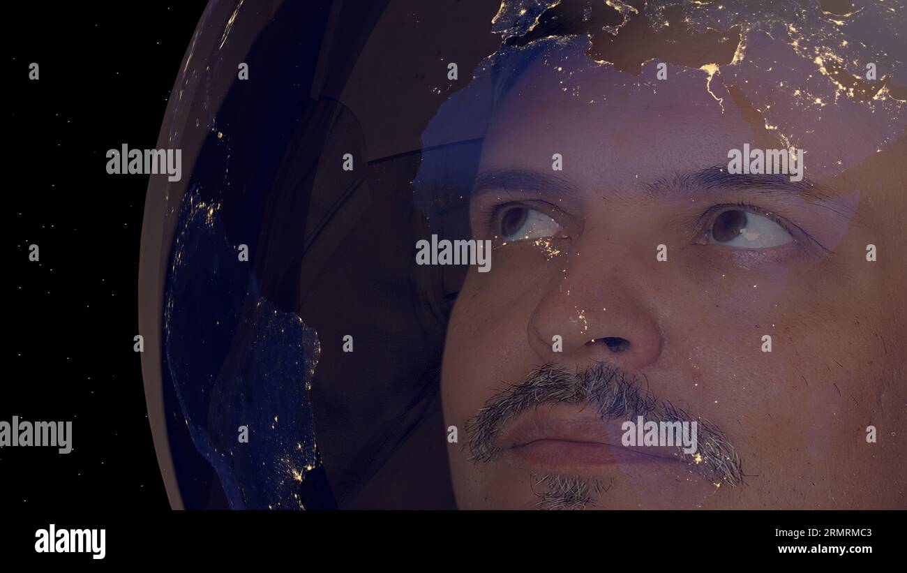 Portrait of man astronaut in outer space wearing helmet looking at ...