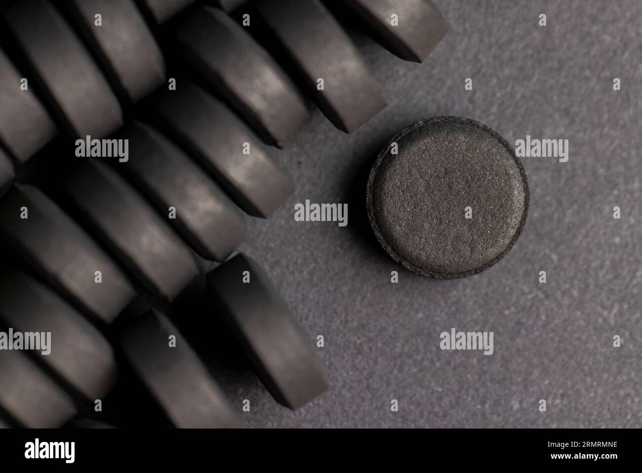 Open and unpacked tablets of black color close-up, several of the same ...