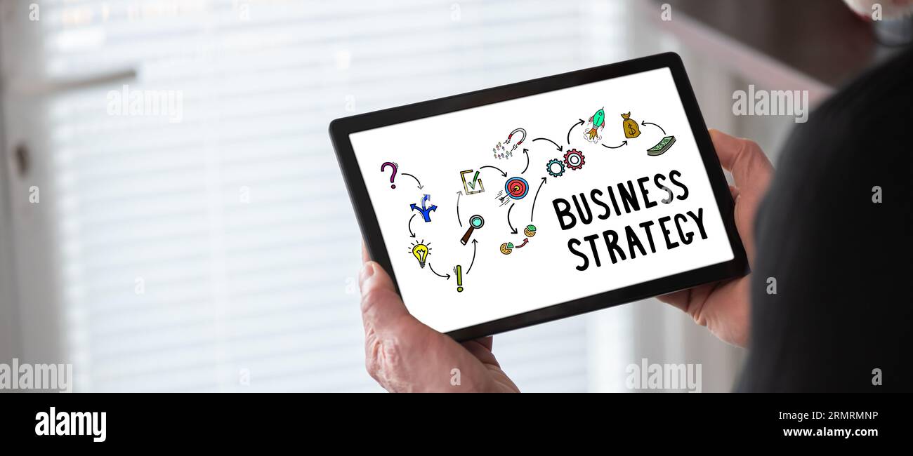 Business strategy concept shown on a tablet held by a man Stock Photo ...