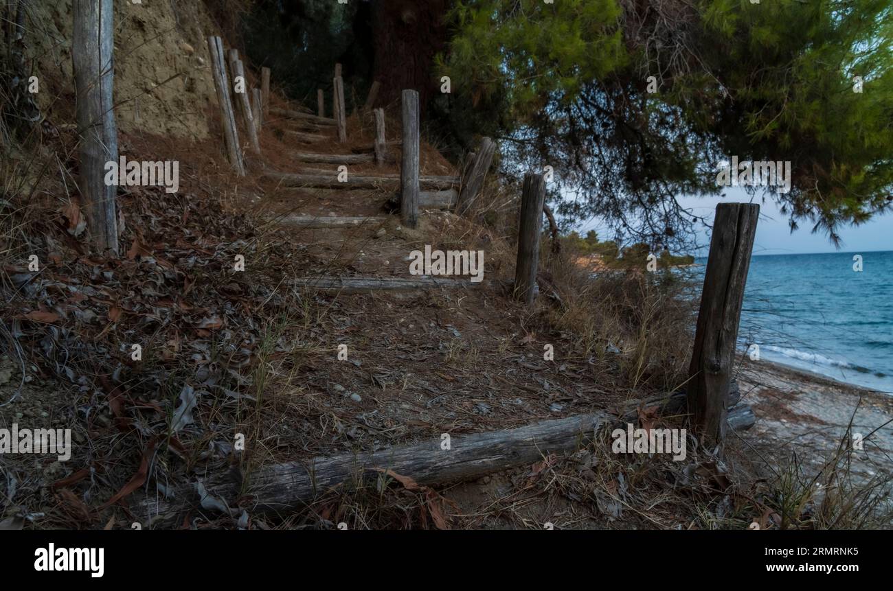 Wooden stairs leading path to Aegean sea beach in Greece at sunset ...