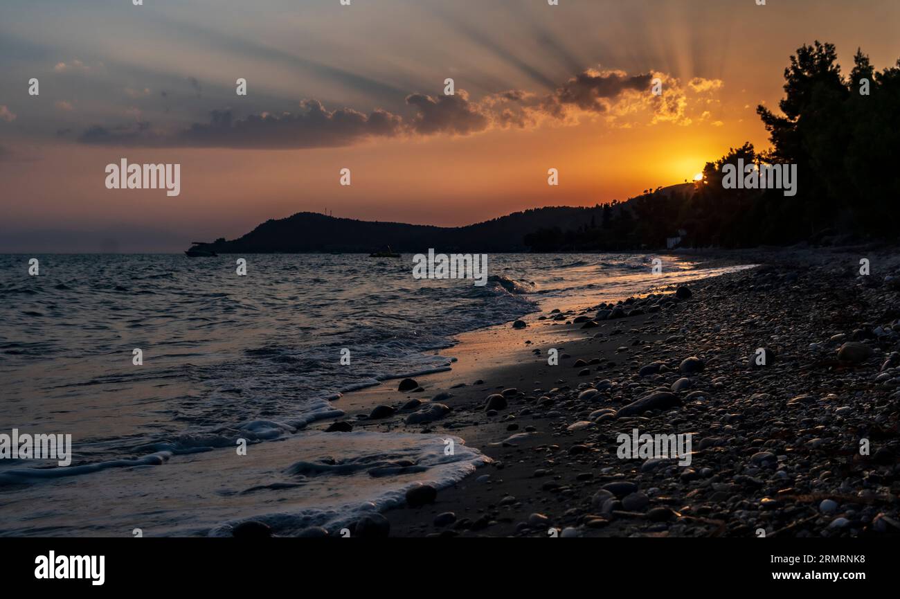 Colourful dramatic sky with cloud at sunset at Aegean sea beach in ...