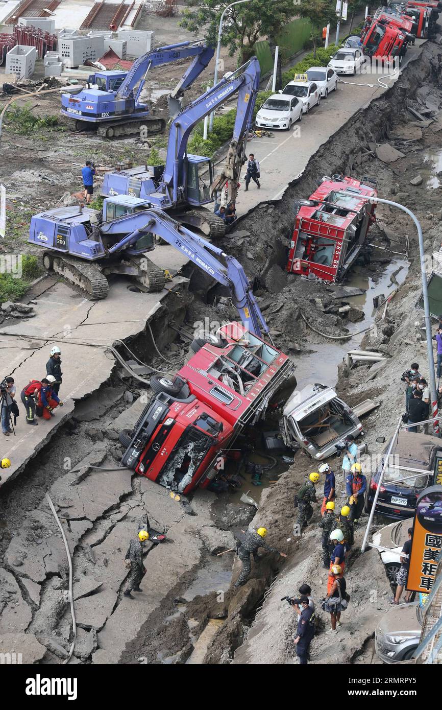 Rescue trucks and rescuers are seen at the site of gas leak explosions ...