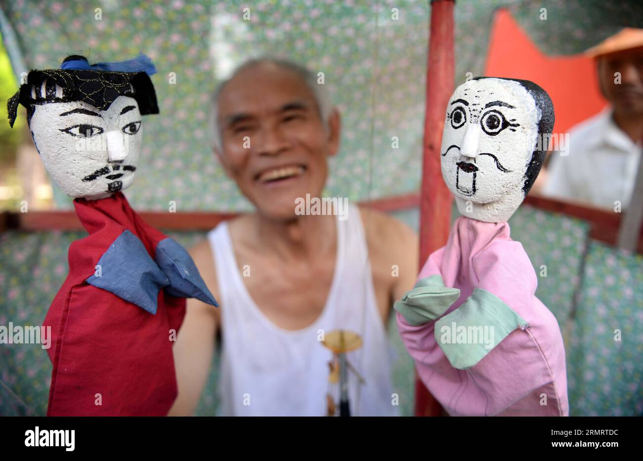 Puppeteer Xiao Qiulin presents his puppets for a show in Yudu County ...