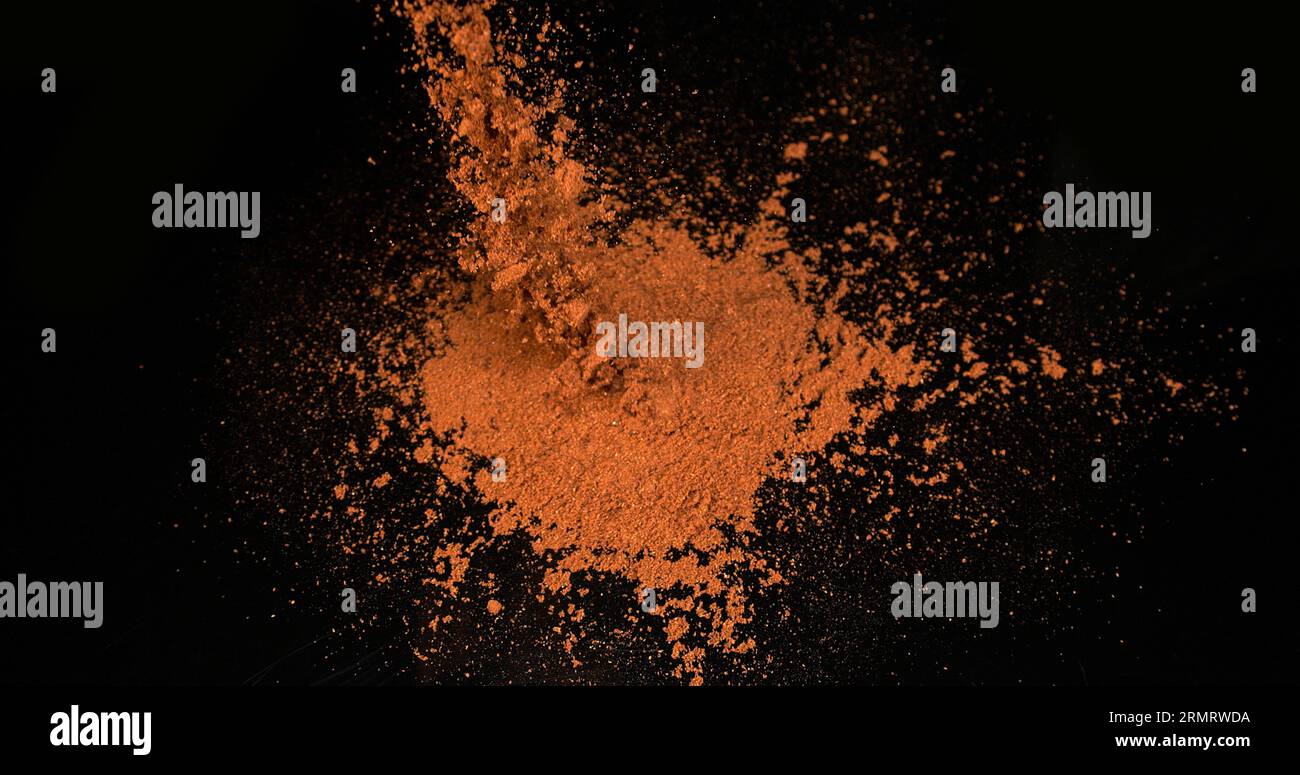 Paprika, capsicum annuum, Powder Exploding against black Background ...