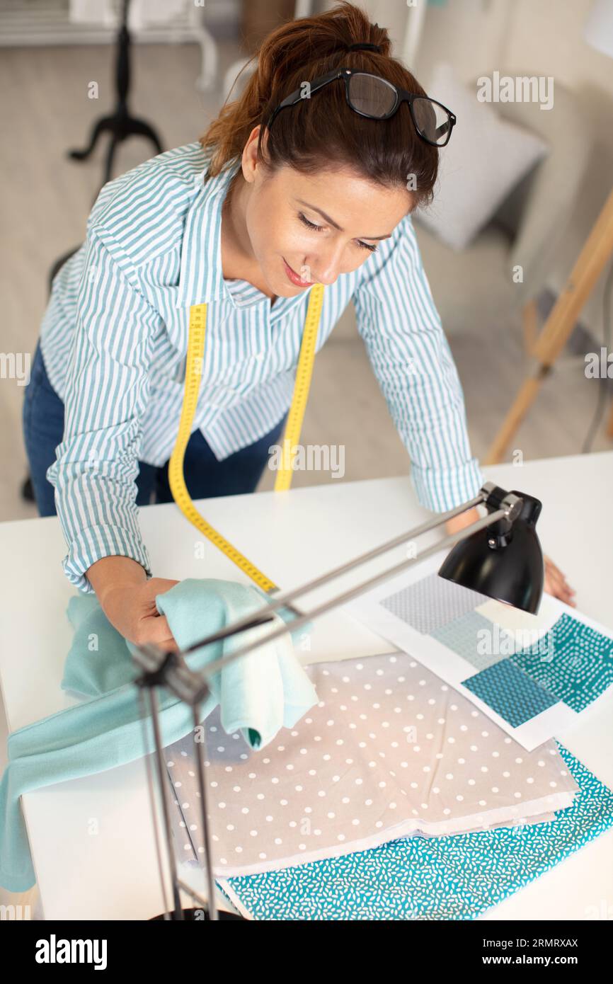 close-up on seamstress measuring fabric Stock Photo - Alamy
