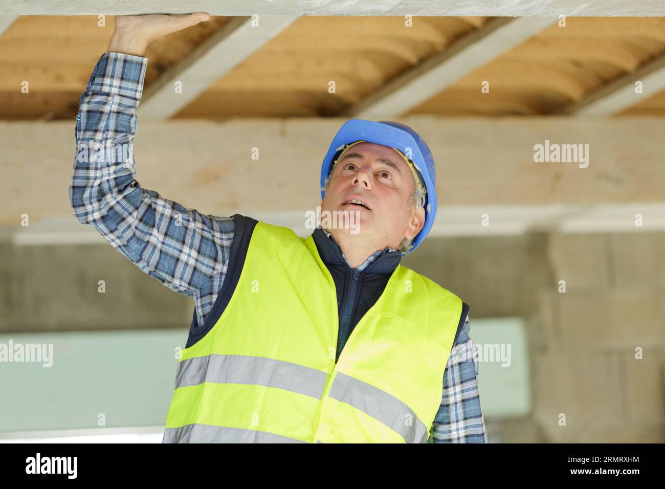 a male worker checking ceiling Stock Photo - Alamy