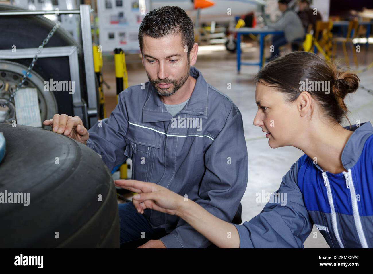 mechanics inspecting the aircraft tire Stock Photo - Alamy