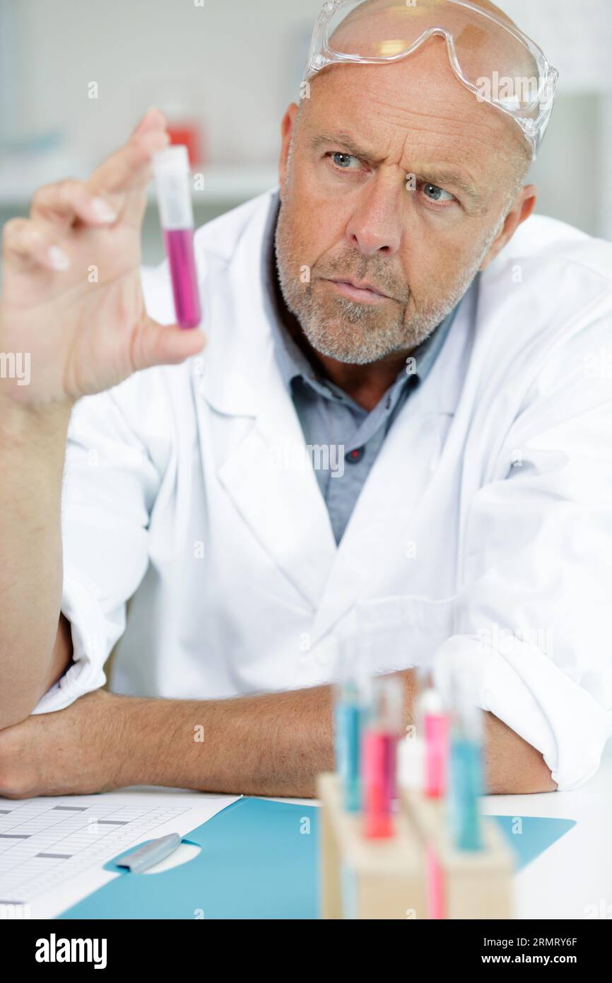 lab man pouring fluids Stock Photo - Alamy