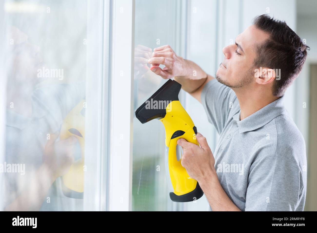 man holding a window steamer Stock Photo - Alamy