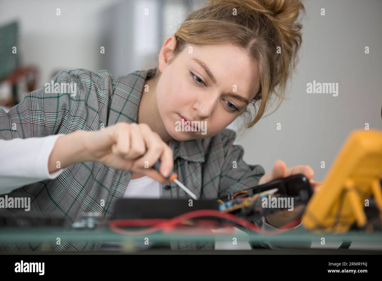 a woman pluging the wire Stock Photo - Alamy