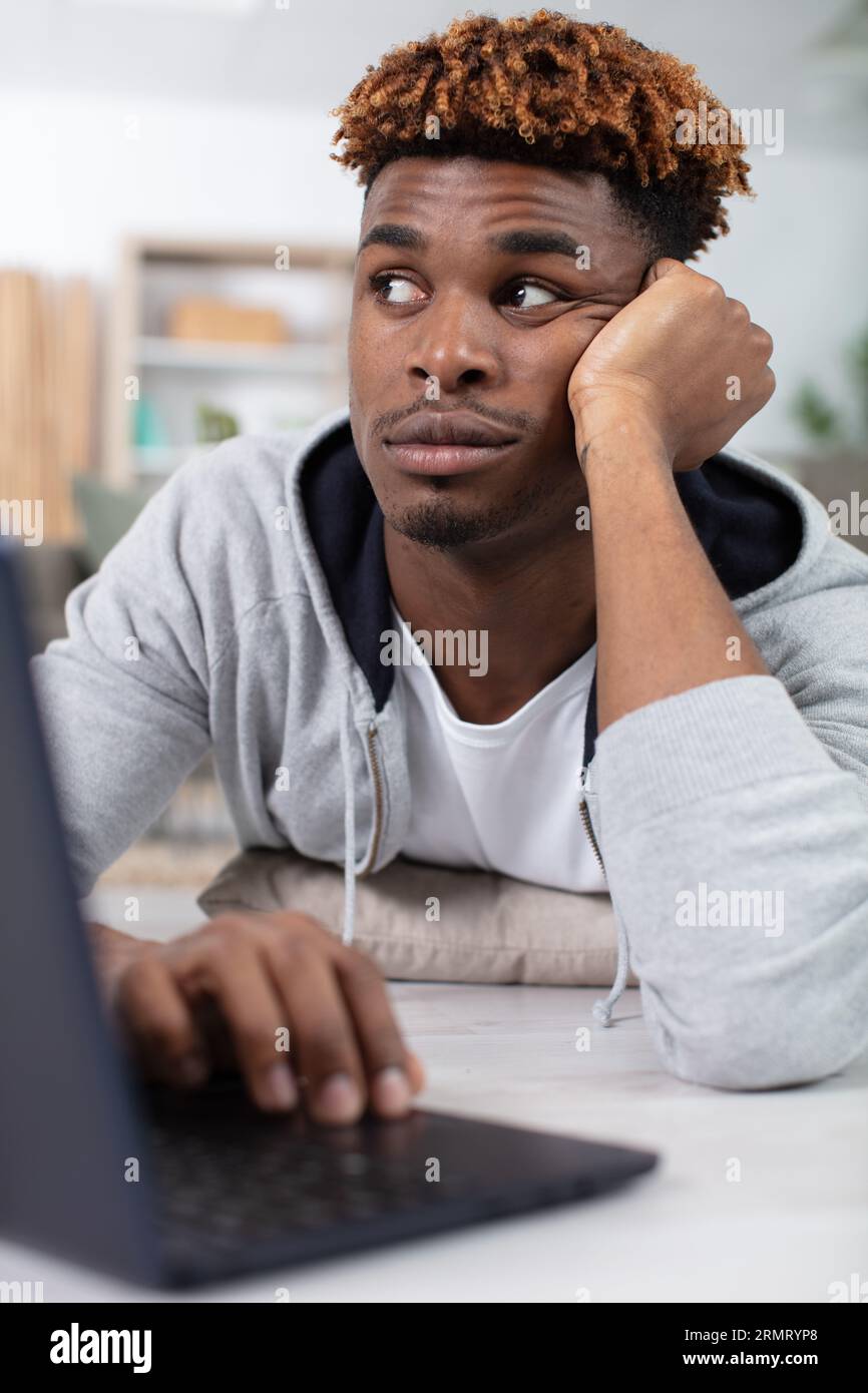 bored young man at the desk Stock Photo - Alamy