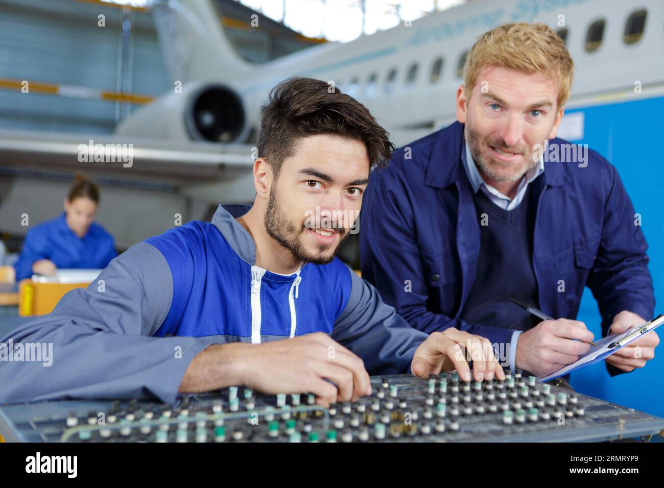 aircraft technical engineers posing and smiling Stock Photo - Alamy