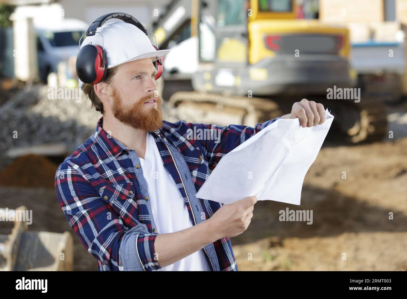 male builder looking at plan outdoors Stock Photo - Alamy