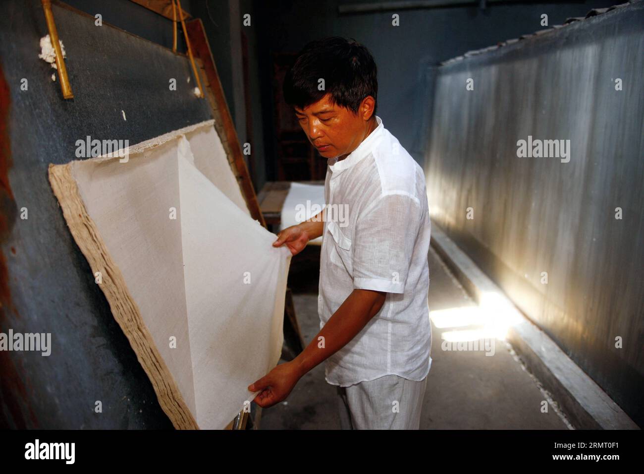 Cao Jianqin puts half-finished Xuan paper for drying in his company in ...